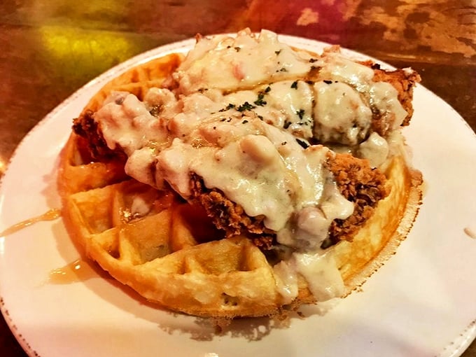 The headliner act: golden Belgian waffle crowned with crispy hand-breaded chicken, smothered in country gravy—a sweet-savory symphony that deserves a standing ovation.