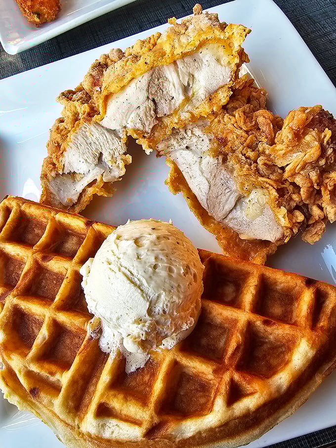 The star attraction: golden-brown chicken perched atop a Belgian waffle with a scoop of brown sugar butter melting seductively. Poetry on a plate.
