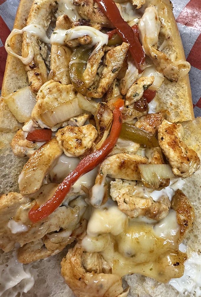 Behold the chicken cheesesteak in all its glory—tender morsels of seasoned chicken embracing melted cheese like long-lost lovers finally reunited.