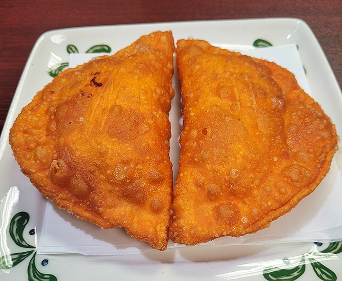 Golden-brown chicken empanadas with that perfect crispy-to-soft ratio—the kind of hand-held happiness that makes you wonder why you'd ever eat anything else.