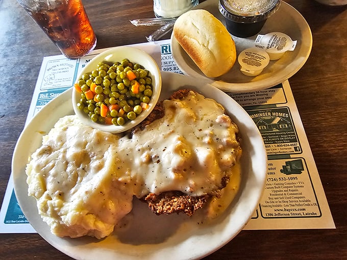 Behold the star of our show! Chicken fried steak swimming in pepper-flecked gravy with mashed potatoes and peas. Comfort food that hugs your soul.
