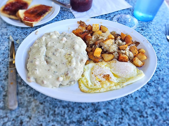 Biscuits and gravy that could make a cardiologist weep—gloriously creamy, perfectly peppered, and worth every single delicious calorie.