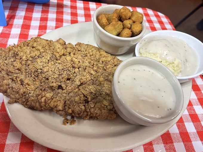 This chicken fried steak isn't just dinner—it's an edible monument to Southern cooking. The cream gravy alone deserves its own fan club.