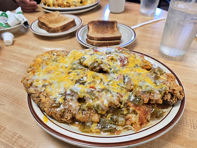Behold the legendary chicken fried steak in all its glory – crispy coating, smothered in green chile and cheese. Diet plans come here to die.