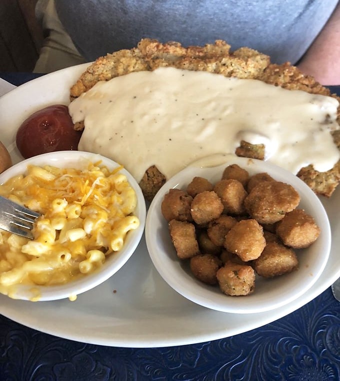 Behold the star attraction: chicken fried steak draped in cream gravy alongside mac and cheese that would make your childhood self high-five your adult self.