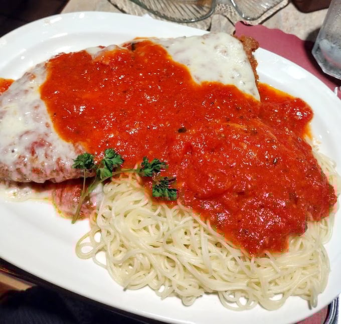 The legendary chicken parm in all its glory—where marinara meets mozzarella in a romance that would make Shakespeare weep with hunger.