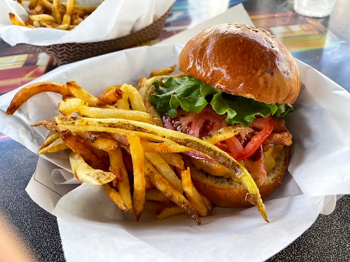 This isn't just a burger—it's edible architecture. Notice how the golden bun domes perfectly over those fresh veggies like a Renaissance painting.