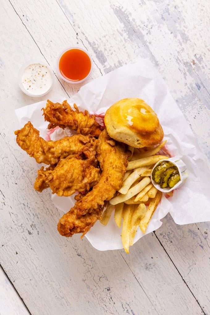 Golden-battered chicken strips that shatter at first bite, served with hand-cut fries and a biscuit that would make any Southern grandmother proud.