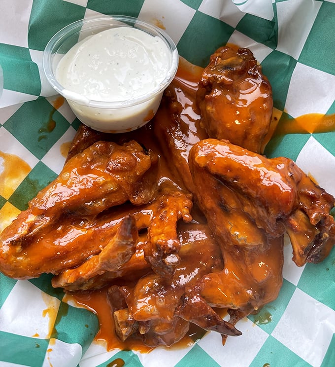 These wings aren't just good; they're "text-your-friends-immediately" good. Glistening with buffalo sauce and begging for that blue cheese bath.