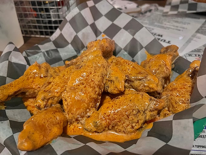 These wings aren't just served—they're presented like the celebrities they are. Golden-brown, sauce-slathered perfection that makes napkins necessary and diets optional.
