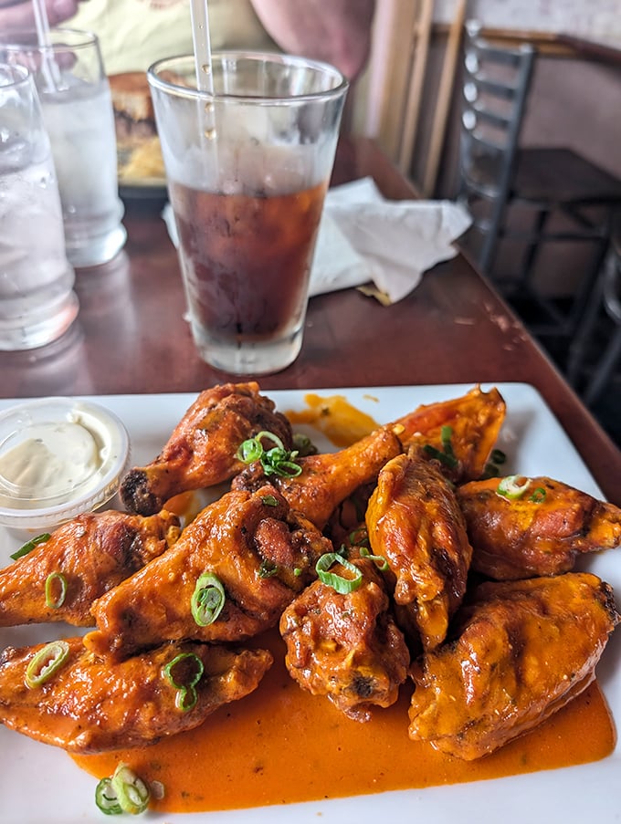 The star attraction arrives! These wings, glistening with sauce and garnished with scallions, aren't just food—they're an Ohio religious experience.