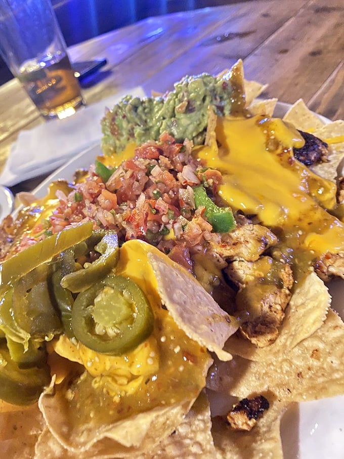 Loaded nachos that don't skimp on toppings – a mountain of melted cheese, fresh salsa, and guacamole that requires a strategic eating plan.