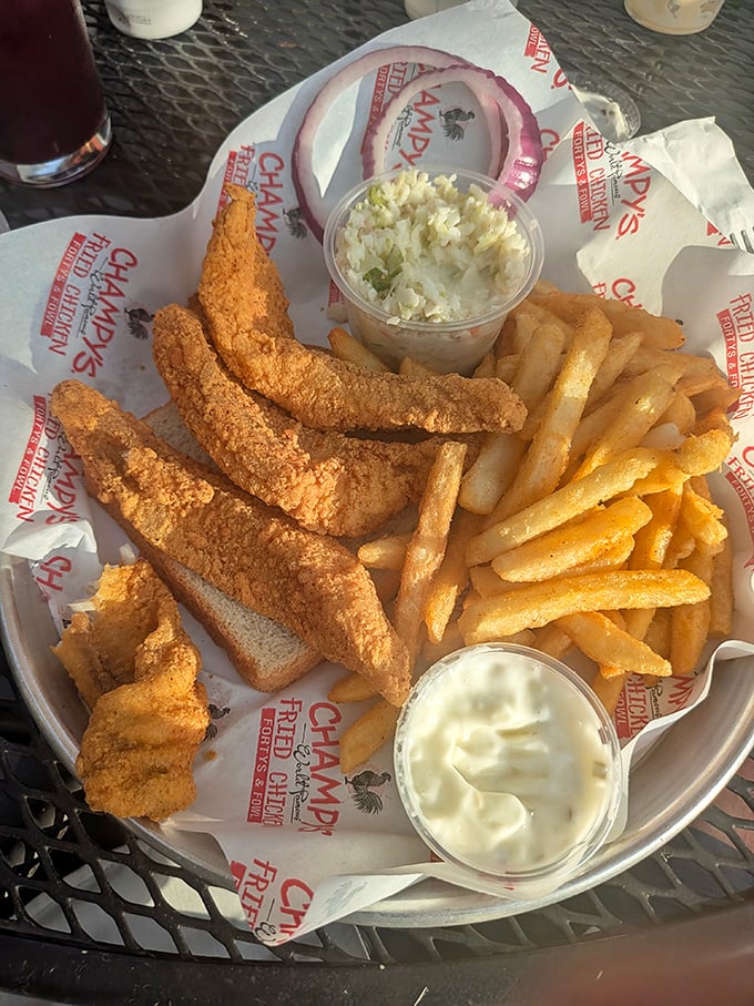 Golden-fried chicken tenders that could make a vegetarian weep with temptation, served with crispy fries and creamy coleslaw. Comfort food perfection.