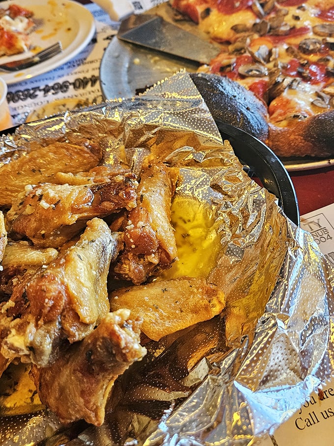 Golden-brown wings nestled in foil – the humble presentation belies the flavor explosion waiting to happen. These aren't just wings; they're edible joy.