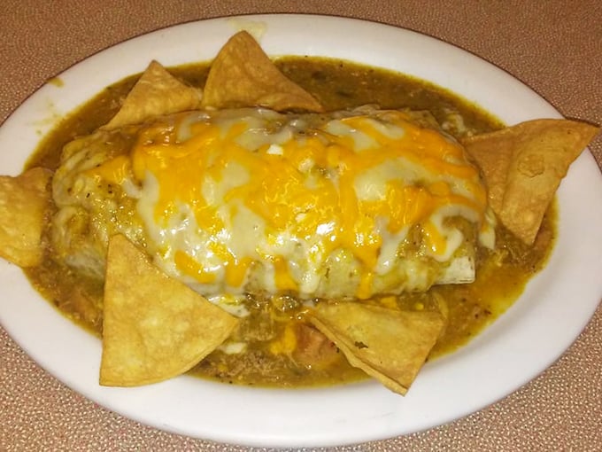 The legendary chile relleno burrito in all its saucy, cheese-crowned glory – like a Mexican flavor piñata that's already burst open.