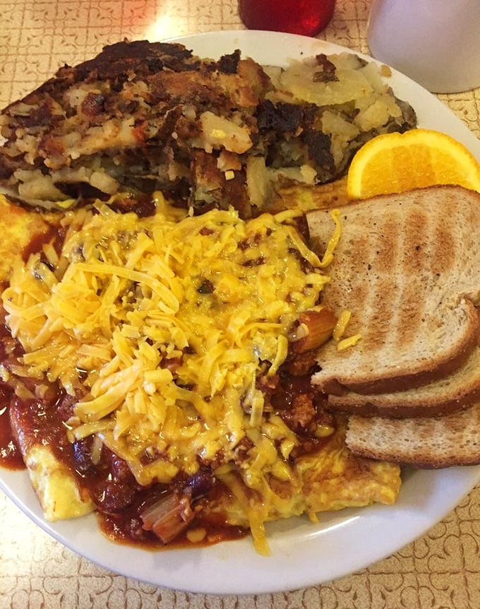 The kind of breakfast that makes lunch optional and dinner a distant concept – Mickey's famous chili cheese omelette with a side of perfectly crisped hash browns.