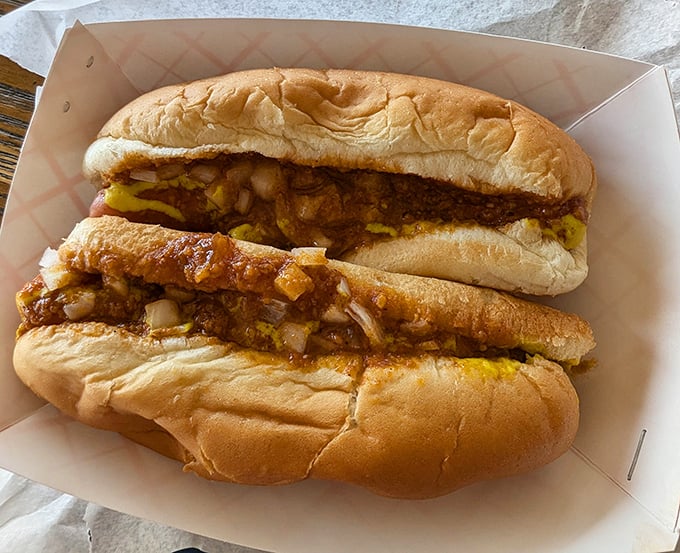 Not all heroes wear capes – some come nestled in soft buns, draped in perfectly seasoned chili and diced onions that make taste buds stand at attention.