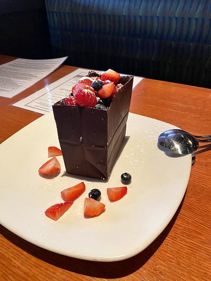 Behold the legendary chocolate bag—an architectural marvel of sweetness. Fresh berries peek out like treasures from a delicious chocolate pirate chest.
