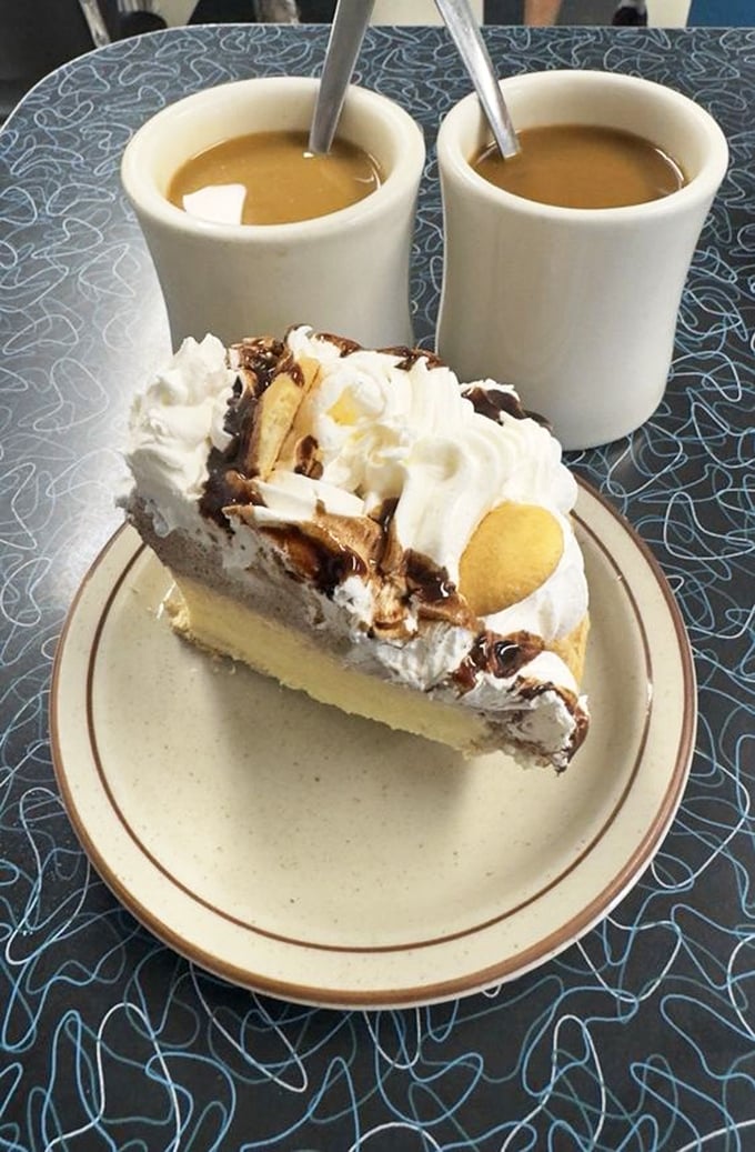 This isn't just pie – it's a towering monument to dessert perfection, where banana cream and chocolate unite with whipped cream in sweet harmony.