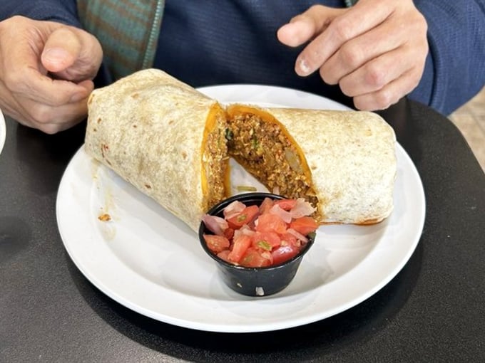 Behold the famous chorizo burrito—a masterpiece wrapped in a tortilla with fresh pico de gallo standing by, ready for its supporting role.