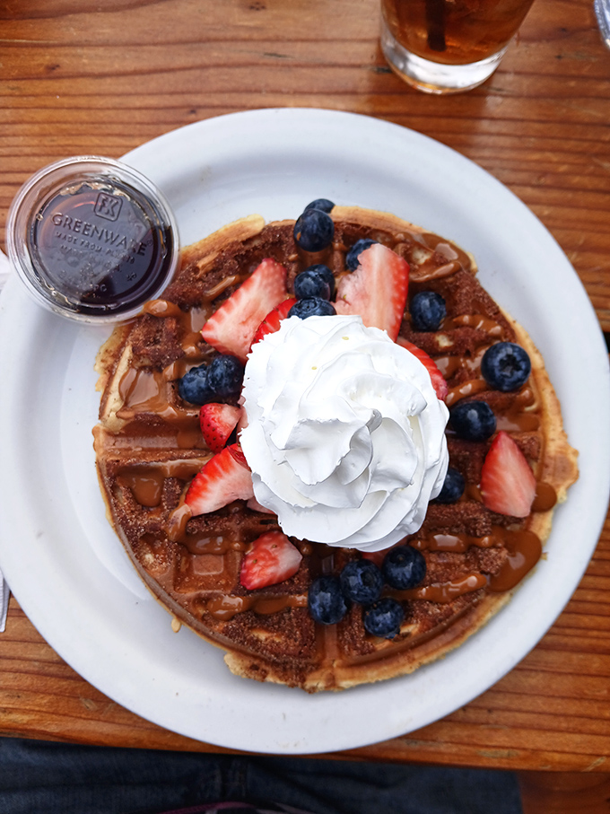 Not all heroes wear capes—some wear whipped cream and berries atop a golden churro waffle that would make angels weep with joy.