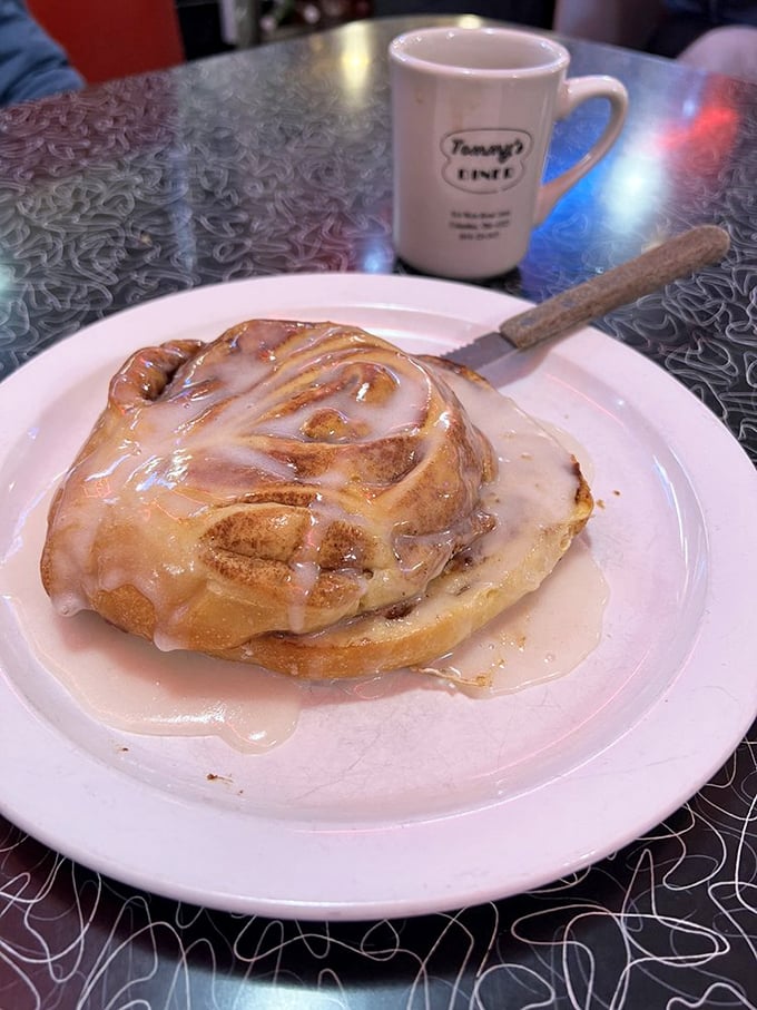 The cinnamon roll at Tommy's doesn't just arrive at your table—it makes an entrance, glistening with glaze and demanding your full attention.