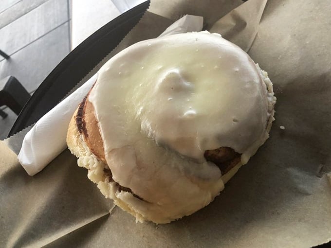 Behold, the reason people set morning alarms: a cinnamon roll with frosting so generous it's practically wearing a winter coat.