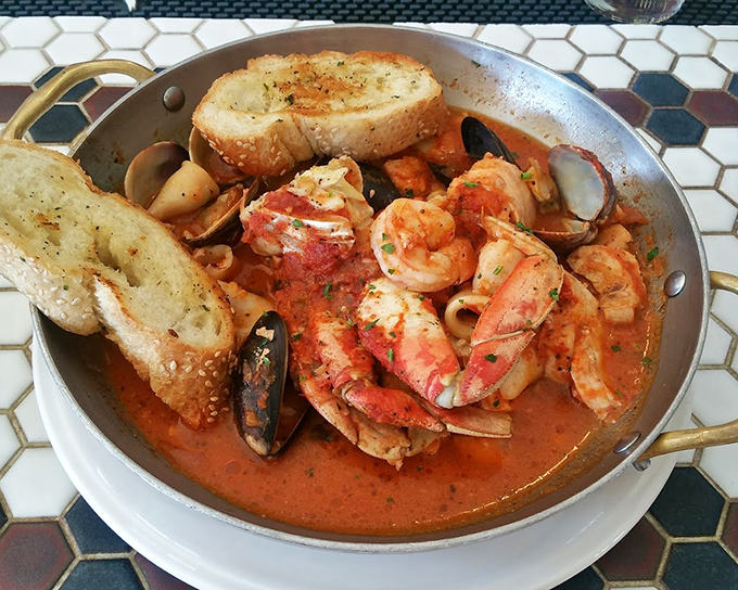 Cioppino that would make Neptune himself weep with joy – a tomato-based sea of treasures where every spoonful tells a different delicious story.