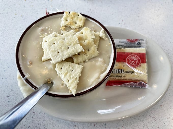 This bowl of New England clam chowder isn't just soup—it's a creamy hug in a bowl, with tender clams and crackers standing by for dunking duty.