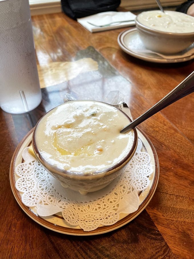 Creamy chowder perfection served on a doily—because even casual comfort food deserves a touch of elegance. One spoonful and you'll understand the devotion.