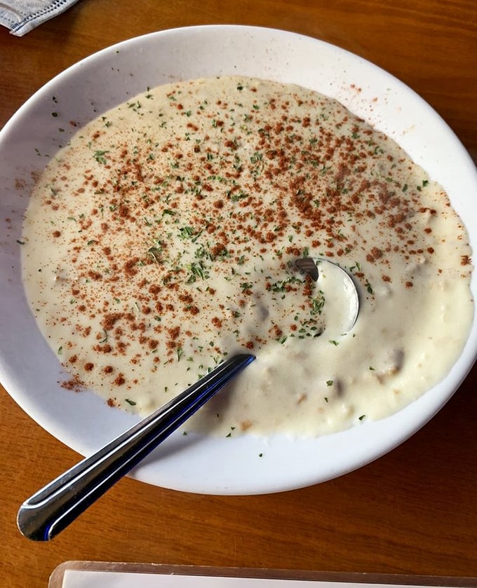 Behold, the holy grail—creamy clam chowder dusted with paprika and herbs. This isn't soup; it's a warm, briny hug in a bowl.
