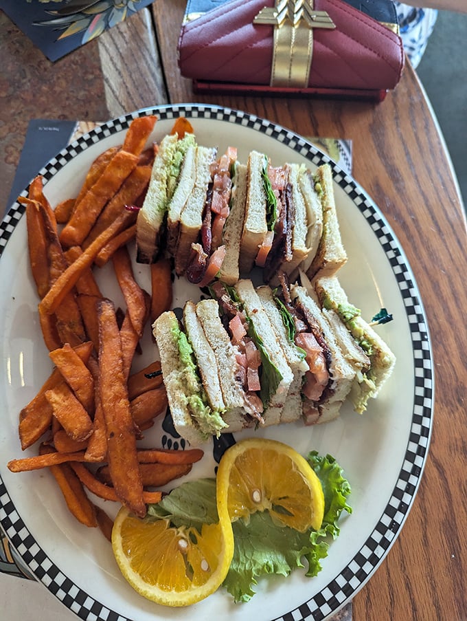 Behold the legendary Club Sandwich—a triple-decker monument to sandwich architecture with perfectly toasted bread, generous fillings, and those fancy little toothpicks.