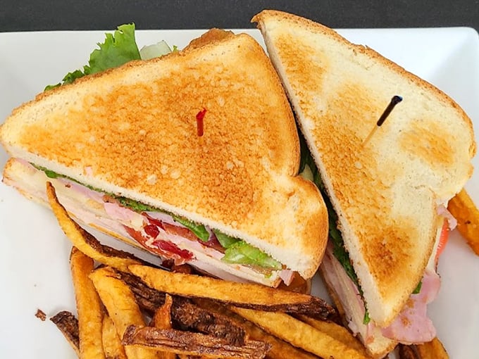 Behold the legendary club sandwich in all its triple-decker glory, where perfectly toasted bread cradles layers of meat and fresh veggies.
