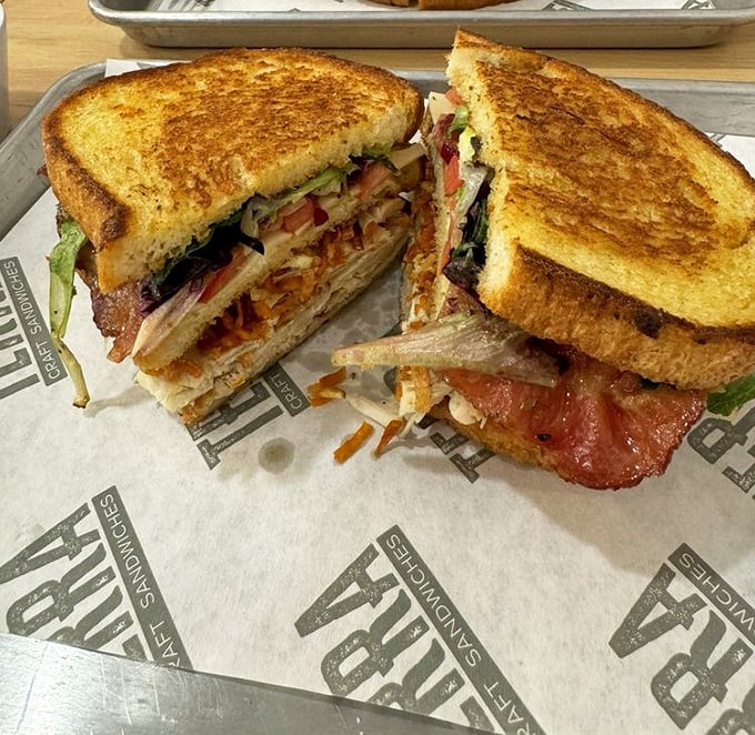 This club sandwich isn't just stacked – it's architected. The golden toast practically winks at you, saying "you made the right choice."