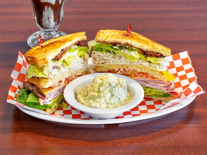 Architecture on a plate! This triple-decker club sandwich doesn't just satisfy hunger—it conquers it with military precision and mayo-based diplomacy.