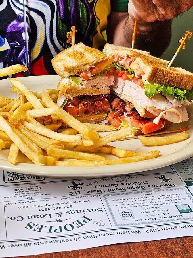 This club sandwich isn't playing around – stacked higher than your weekend to-do list and twice as satisfying when you finally tackle it.