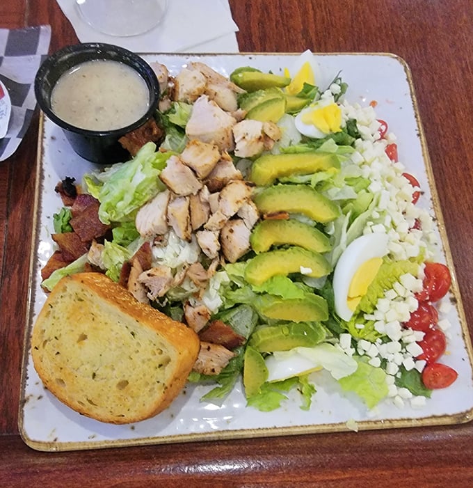 Behold the star attraction – a Cobb salad arranged with such artistic precision, it's practically the Rembrandt of lunch options, complete with perfect avocado fans.