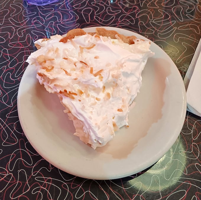The legendary coconut cream pie in all its glory—towering meringue, flaky crust, and coconut perfection. Worth driving across state lines for.