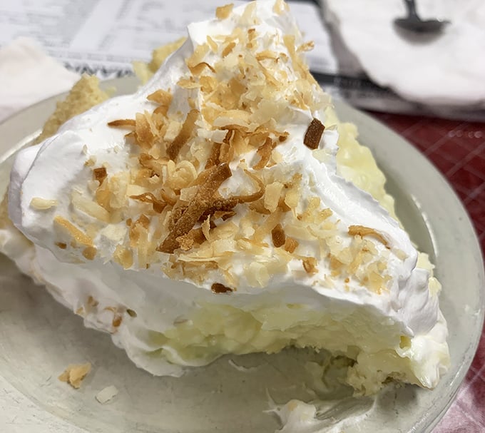 Behold the Everest of coconut cream pie! That meringue defies both gravity and restraint—you'll need to plan a strategy of attack.