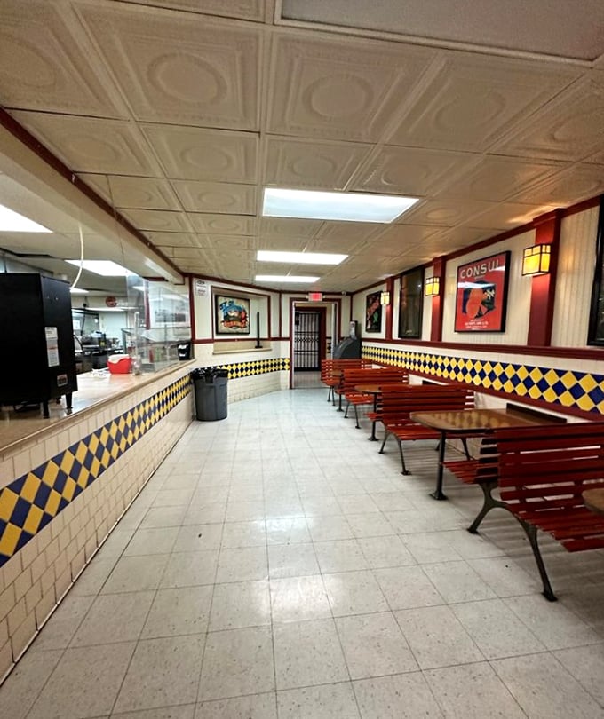 The concession stand's retro charm hasn't changed since your first date here—yellow and blue checkerboard tiles promising nostalgic flavors to come.