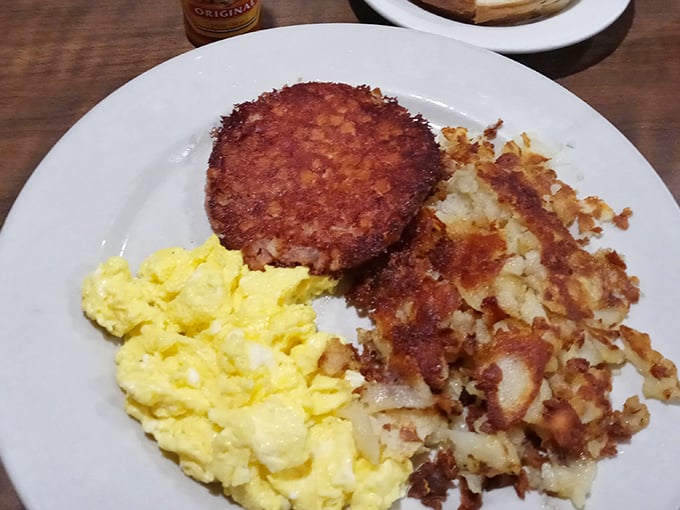 This is what breakfast dreams are made of—golden hash browns with that perfect crisp, fluffy scrambled eggs, and a sausage patty with just the right char.