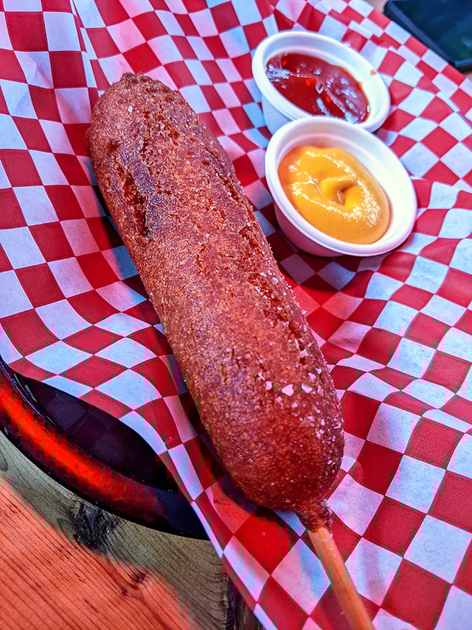 Not all heroes wear capes; some come skewered on sticks. This golden-brown corn dog with house-made sauces might just ruin carnival food for you forever.