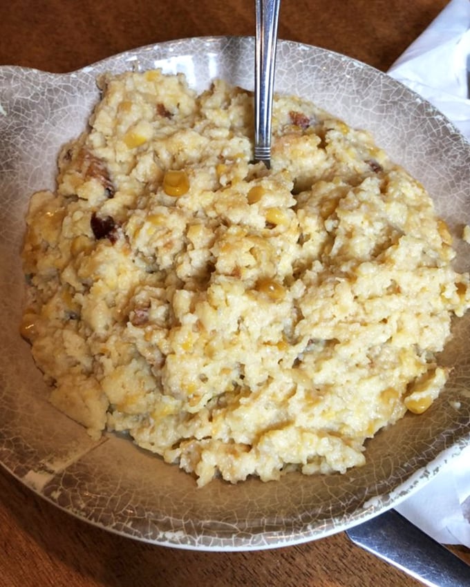 The legendary corn pudding that launched a thousand road trips. Creamy, sweet, and studded with kernels of gold—comfort in a bowl.