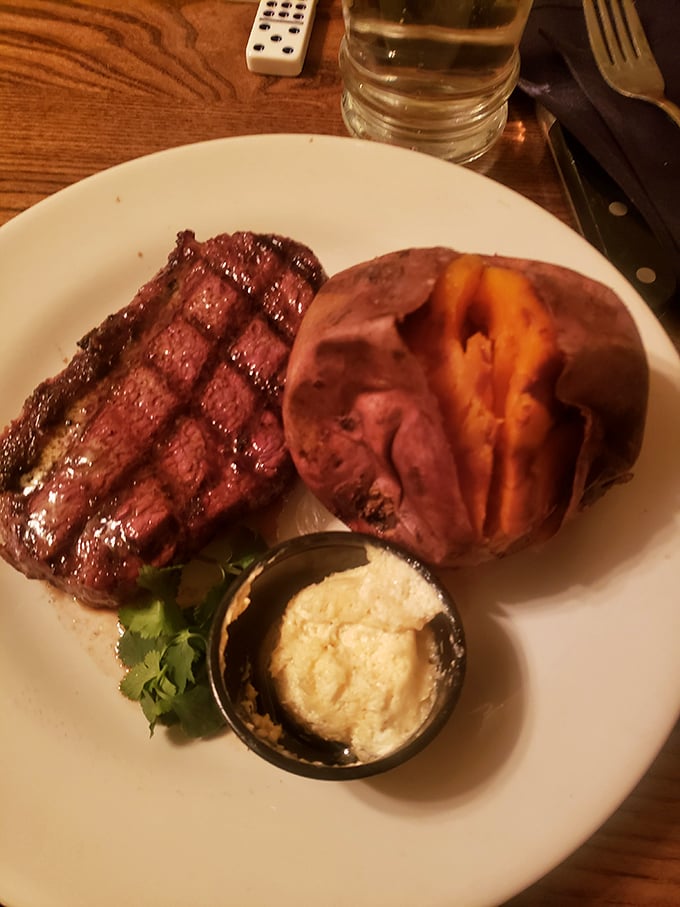 A perfectly grilled steak with a sweet potato that could make a vegetarian question their life choices. This is beef diplomacy at its finest.