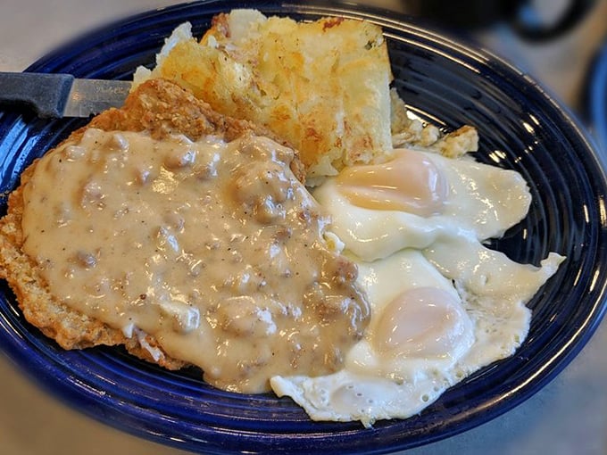 Country fried steak with gravy that cascades like a savory waterfall. This plate doesn't just speak comfort food—it sings it.
