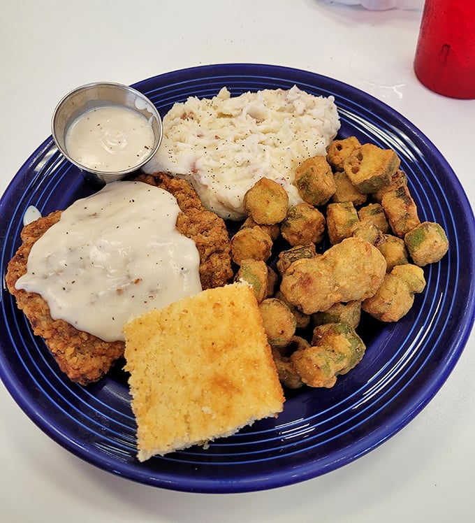 Country fried steak that doesn't just come with gravy—it comes with a guarantee that your diet starts tomorrow. Worth every delicious calorie.
