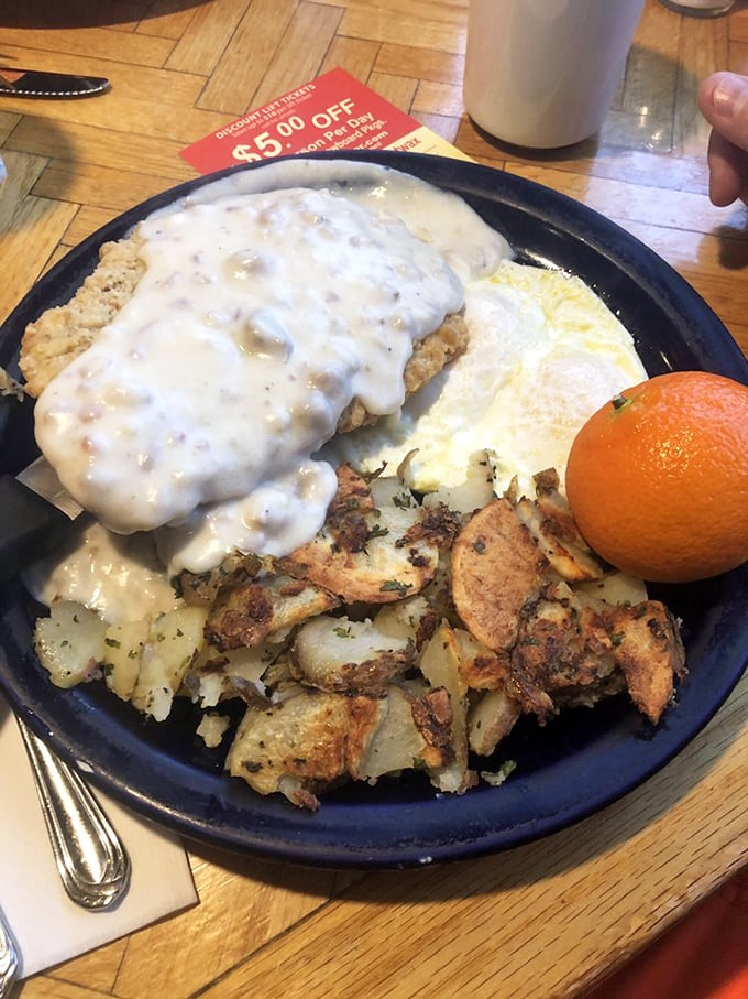 The legendary country fried steak arrives like breakfast royalty—crispy, tender, and swimming in pepper-speckled gravy that deserves its own fan club.