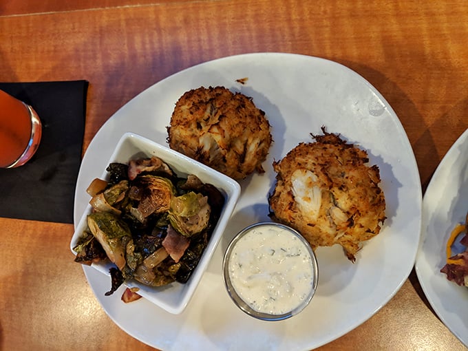 These golden-brown crab cakes aren't just appetizers, they're an event – packed with sweet lump meat and served with a side of culinary revelation.