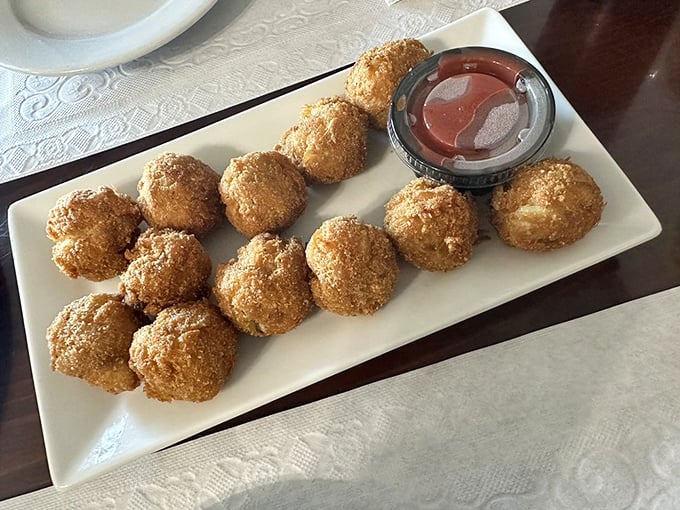 These golden-brown crab balls are the reason people drive for hours. Crispy exterior, tender crab-packed interior—seafood perfection in bite-sized form.