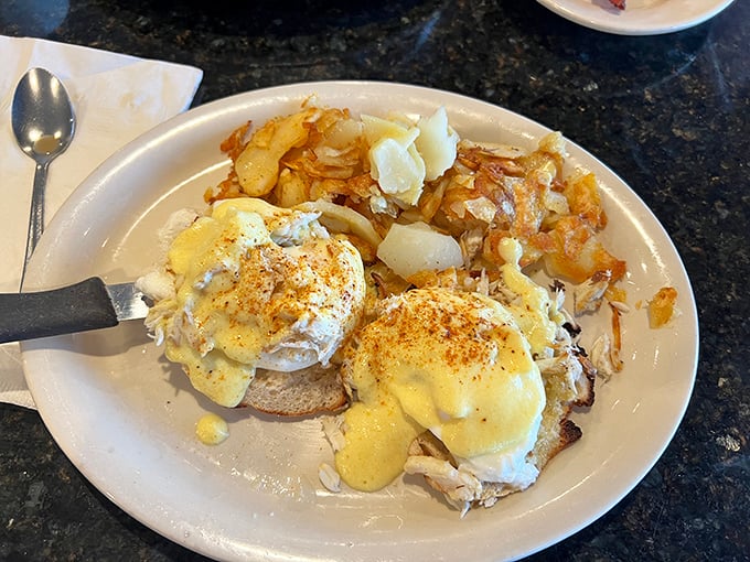 The legendary Crab Benedict in all its glory. Two perfectly poached eggs atop mountains of real lump crabmeat—this breakfast masterpiece might just ruin all other morning meals forever.